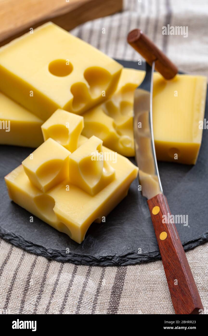 Block of Swiss medium-hard yellow cheese emmental or emmentaler with ...