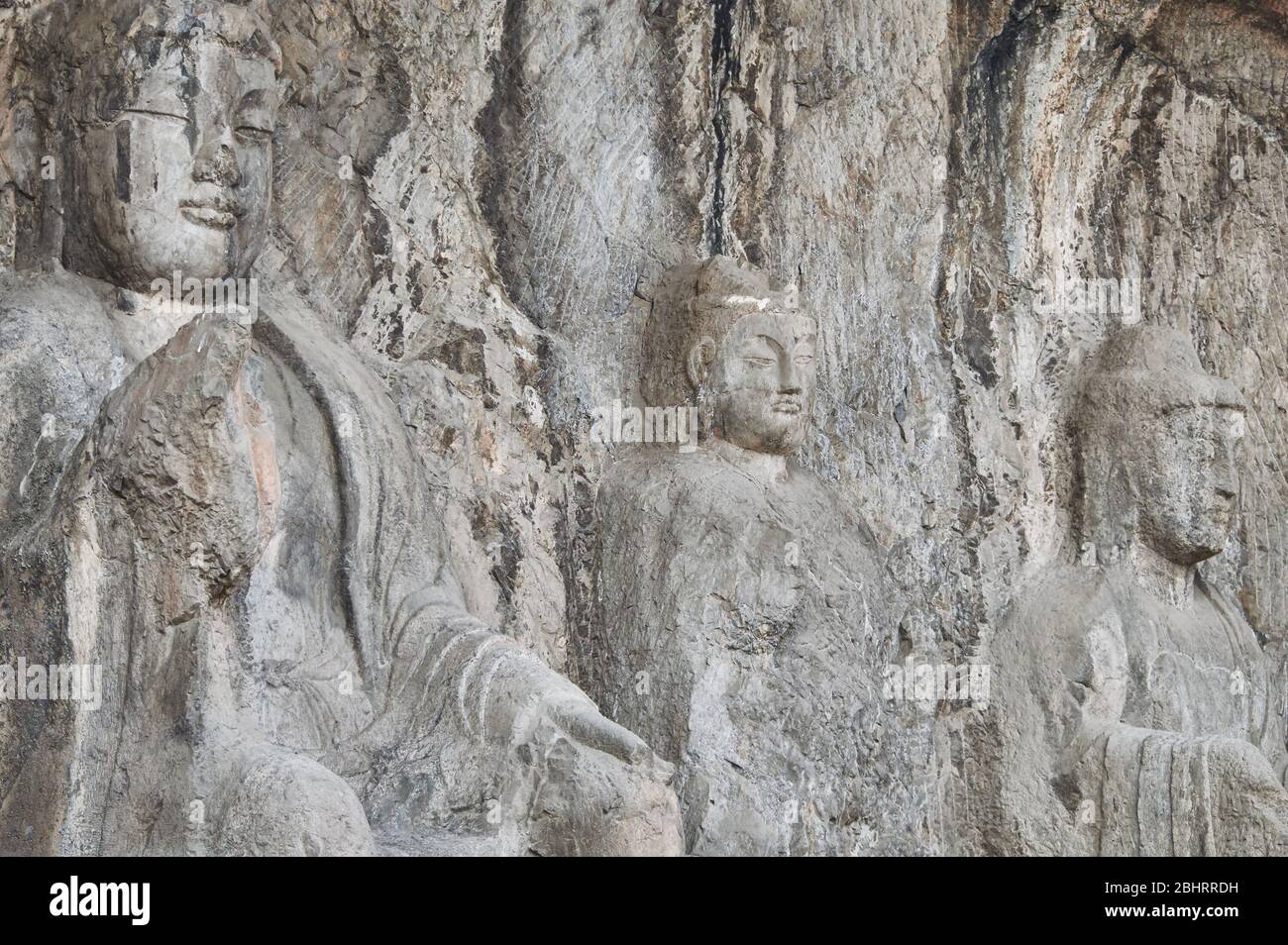 The Longmen Grottoes, Longmen Caves with statues of Buddha and his ...