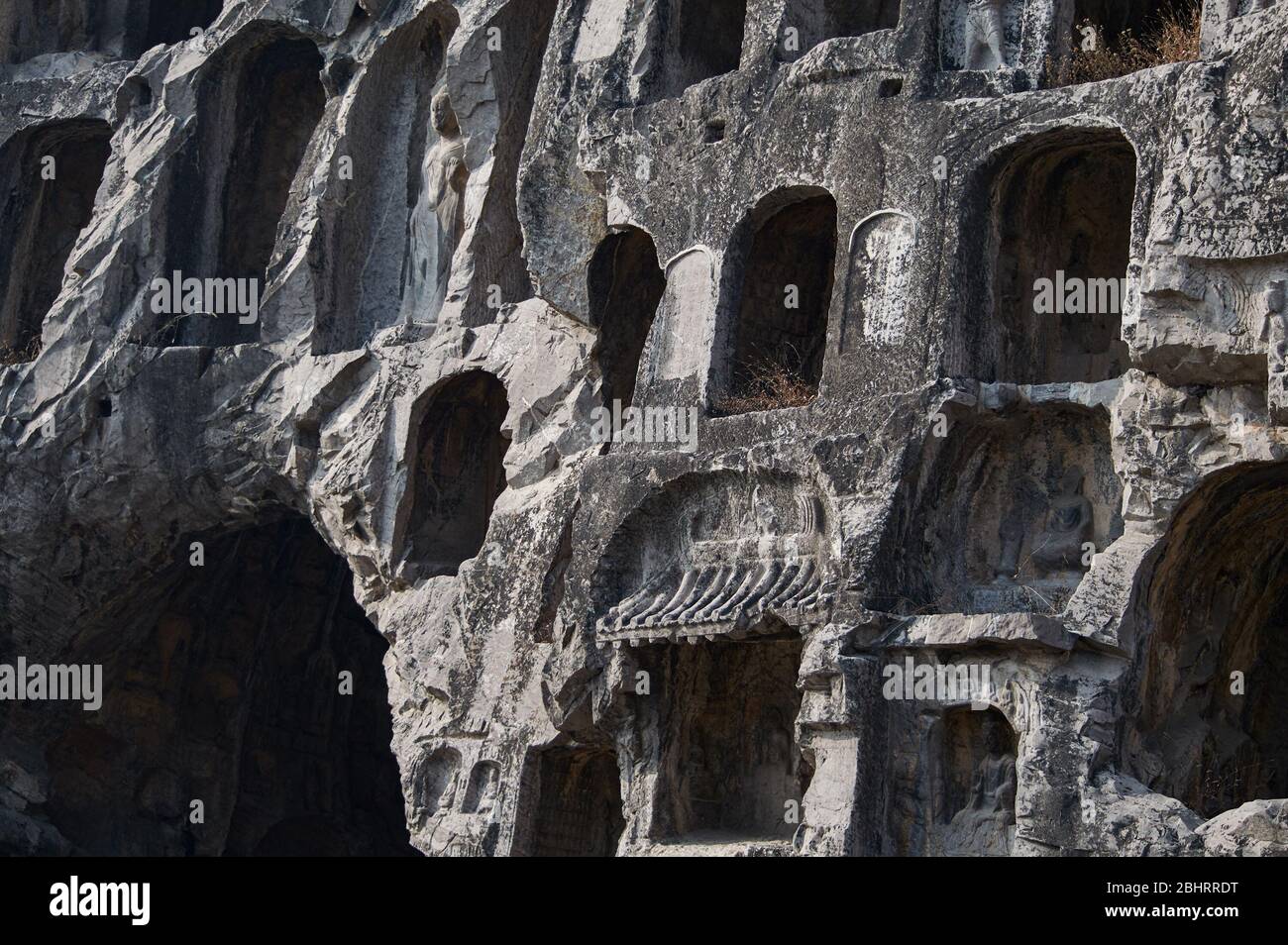 The Longmen Grottoes, Longmen Caves with statues of Buddha and his ...