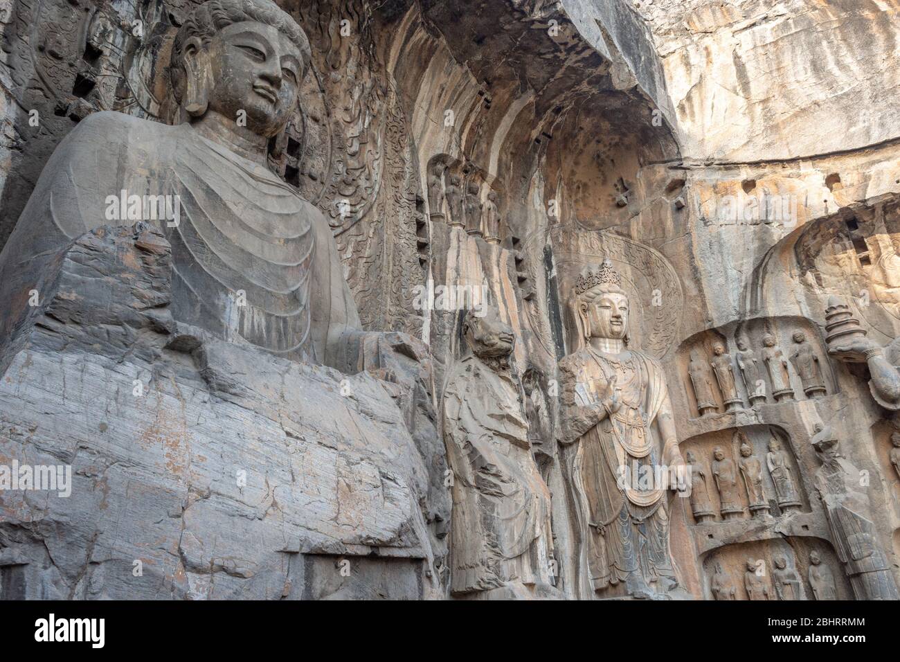 The Longmen Grottoes, Longmen Caves with statues of Buddha and his ...