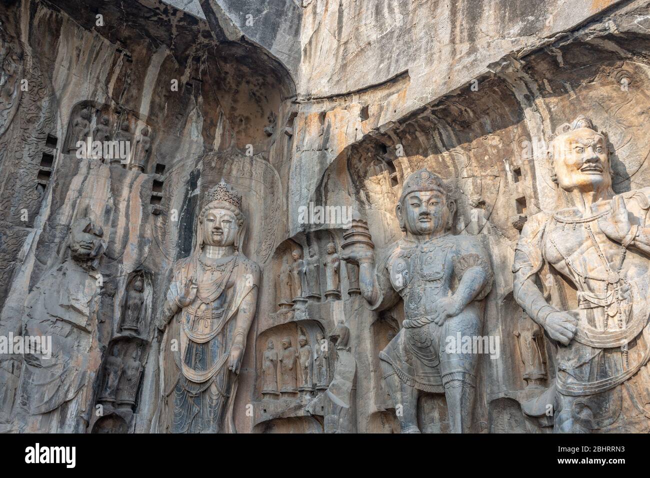 The Longmen Grottoes, Longmen Caves with statues of Buddha and his ...