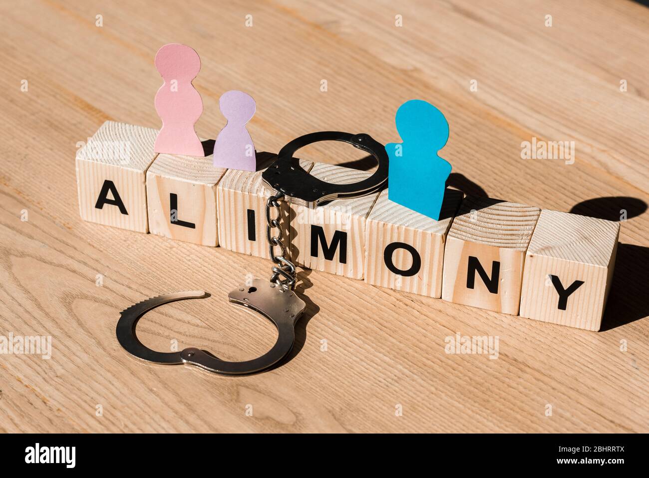 wooden blocks with alimony lettering near family paper cut and ...
