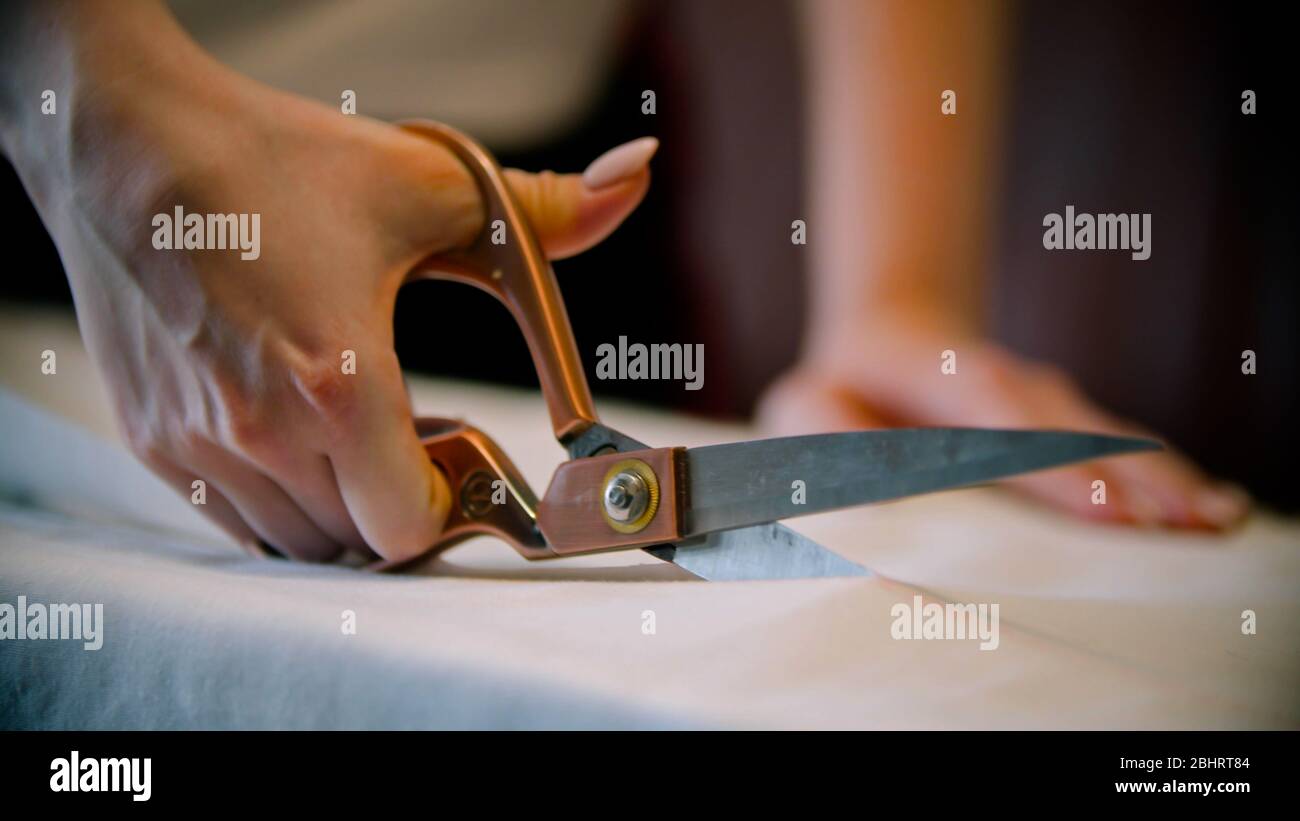 Hand dress making scissors cutting hi-res stock photography and images ...