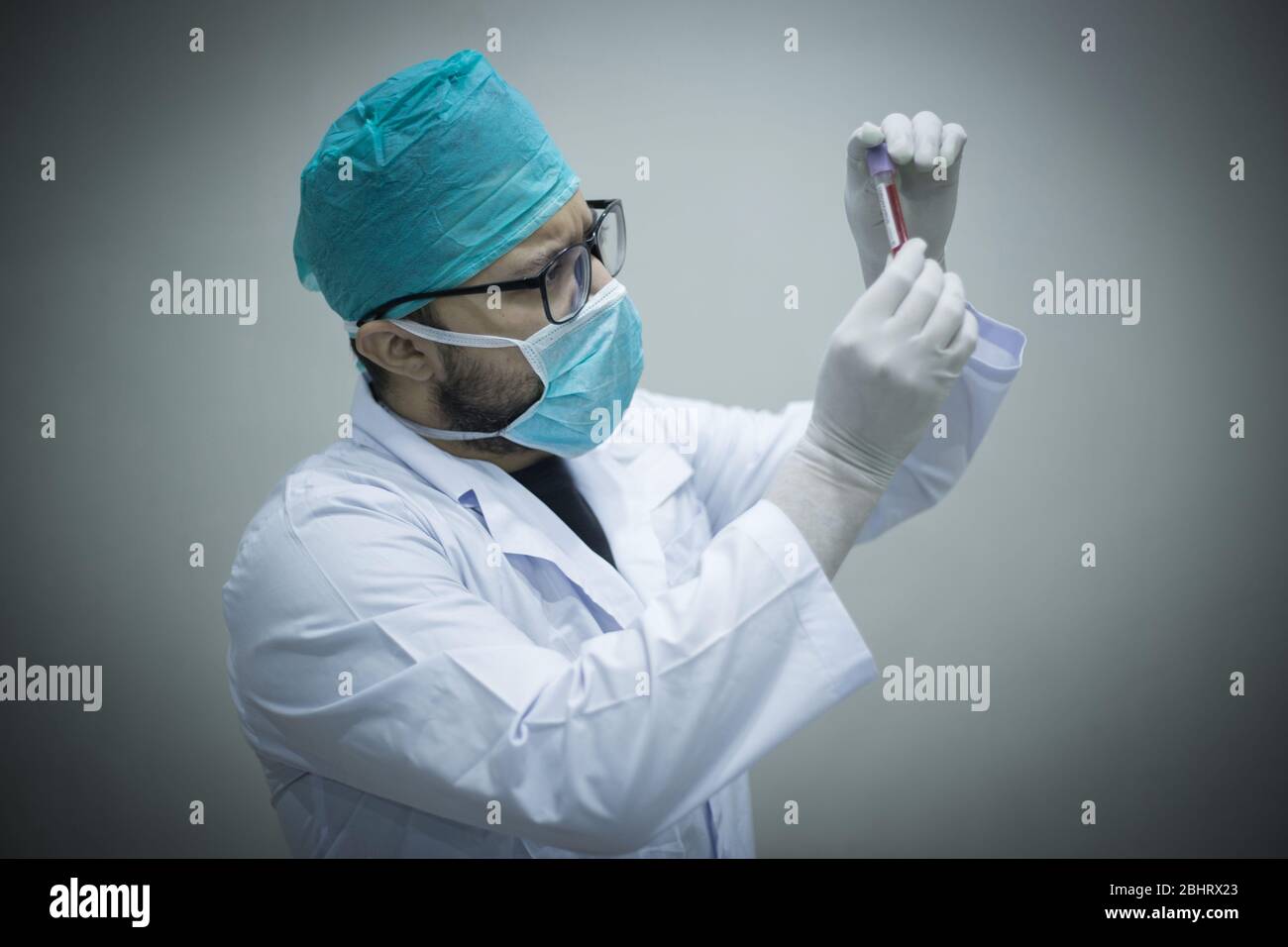 Young Caucasian Doctor Looking At The Blood Sample In A Test Tube ...