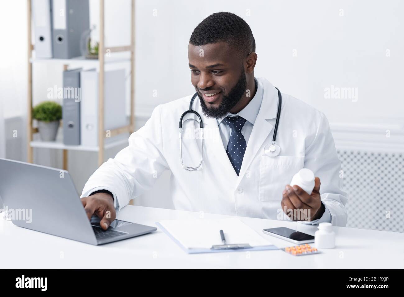 African american male physician checking hi-res stock photography and ...