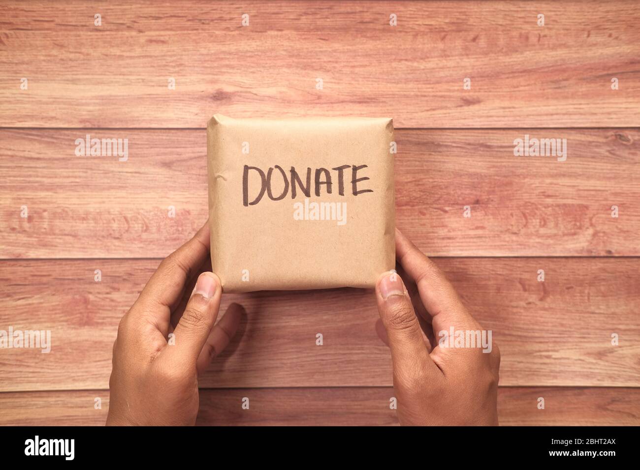 man hand holding donation box, top view Stock Photo - Alamy