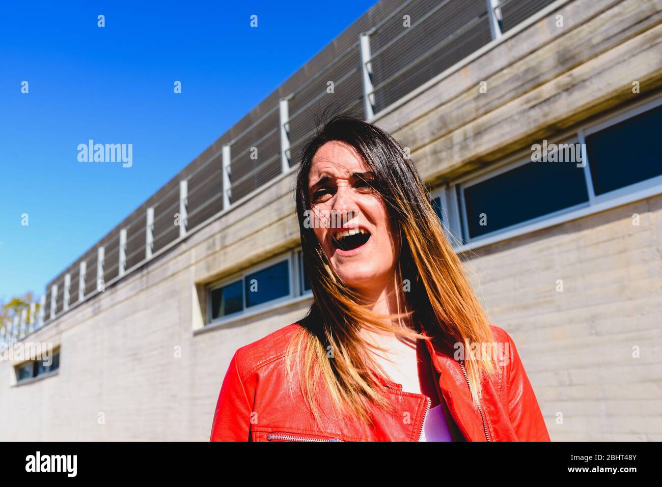 Scared woman is scared and makes a panic face while screaming for help ...