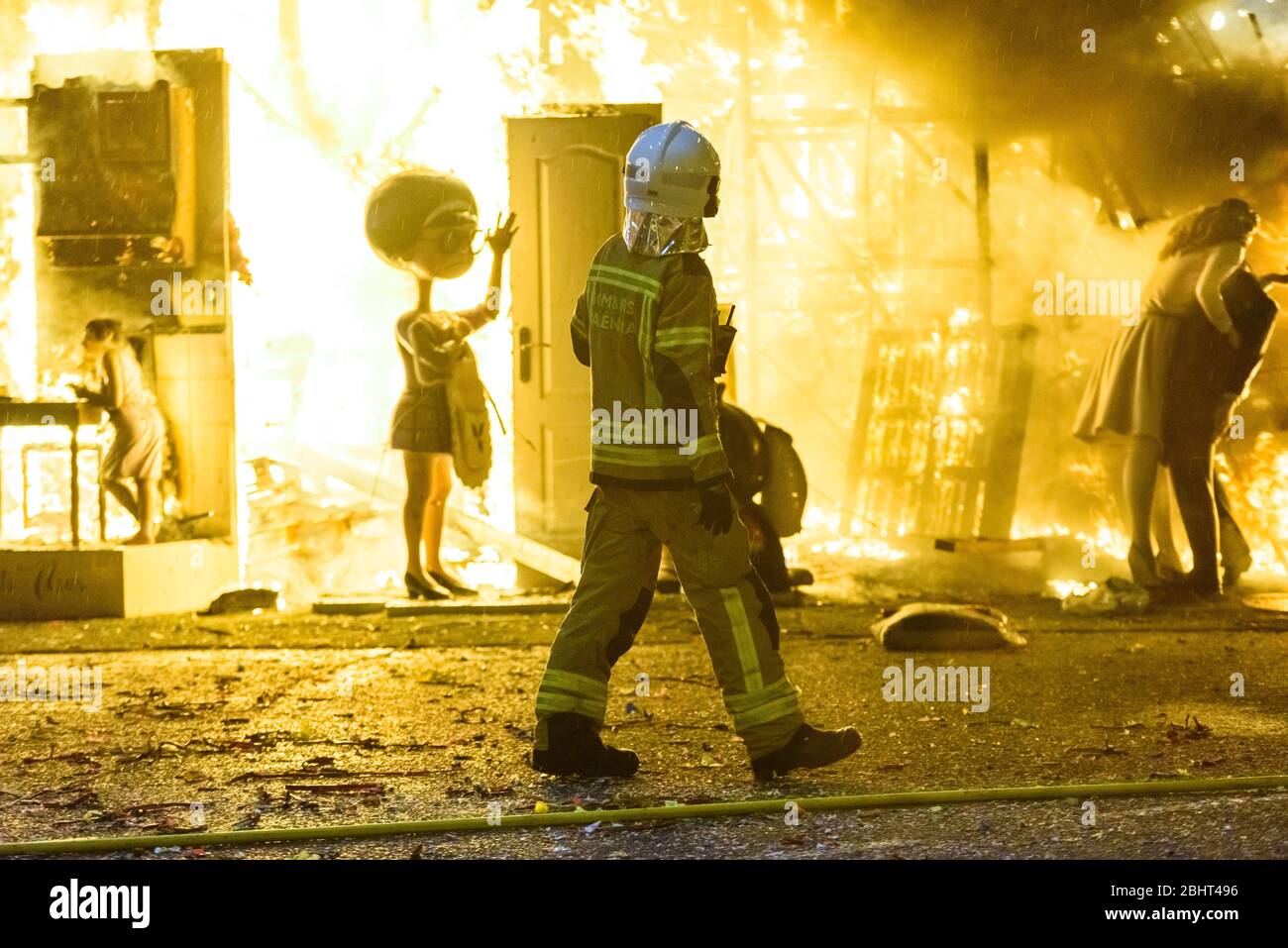 Firefighter with his protective suit working controlling the burning of ...