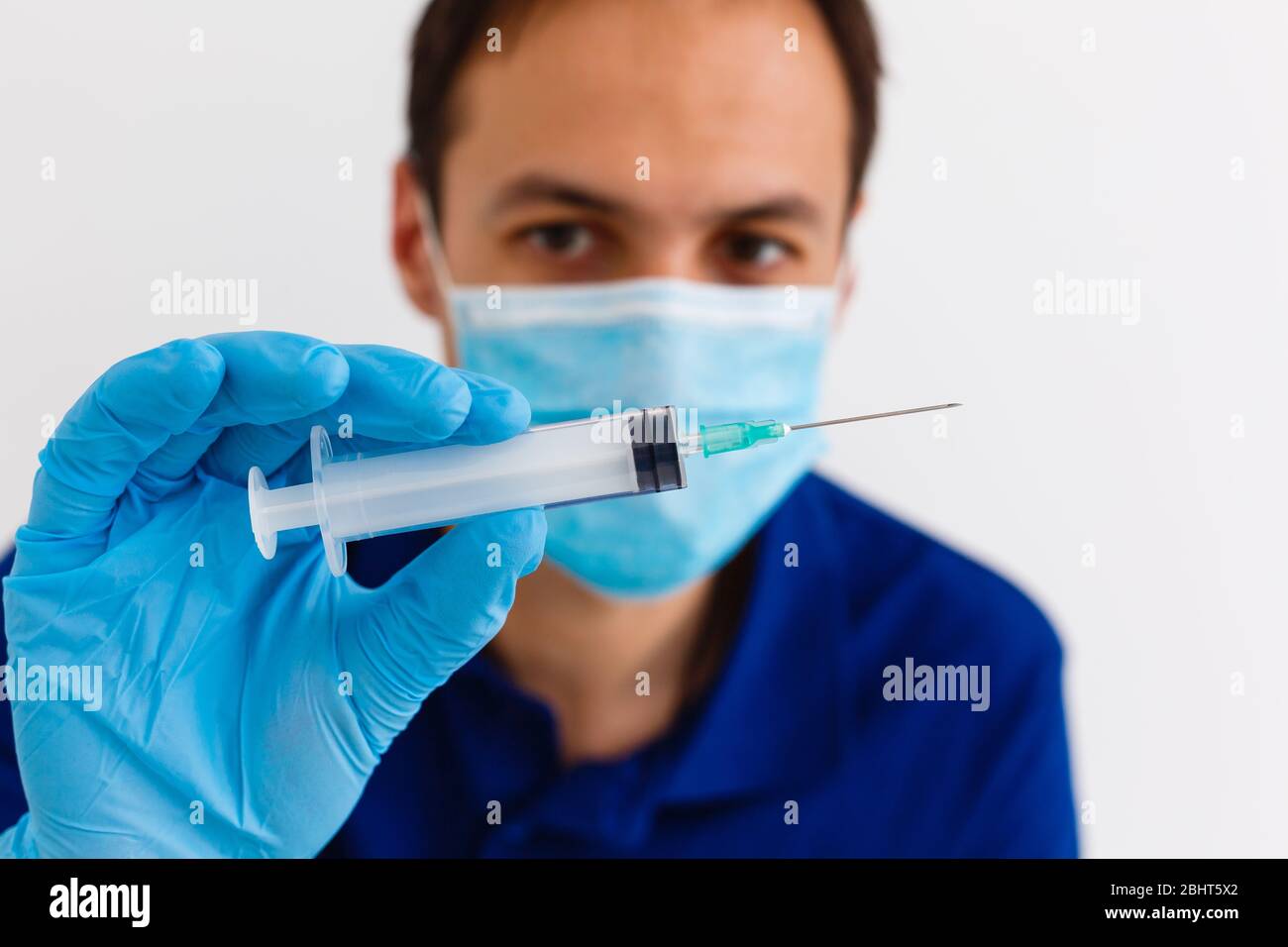 Hand holding syringe isolated on white Stock Photo - Alamy