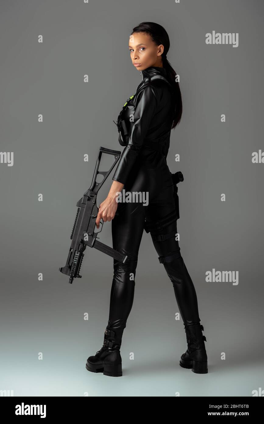 futuristic african american woman with assault rifle on grey Stock ...