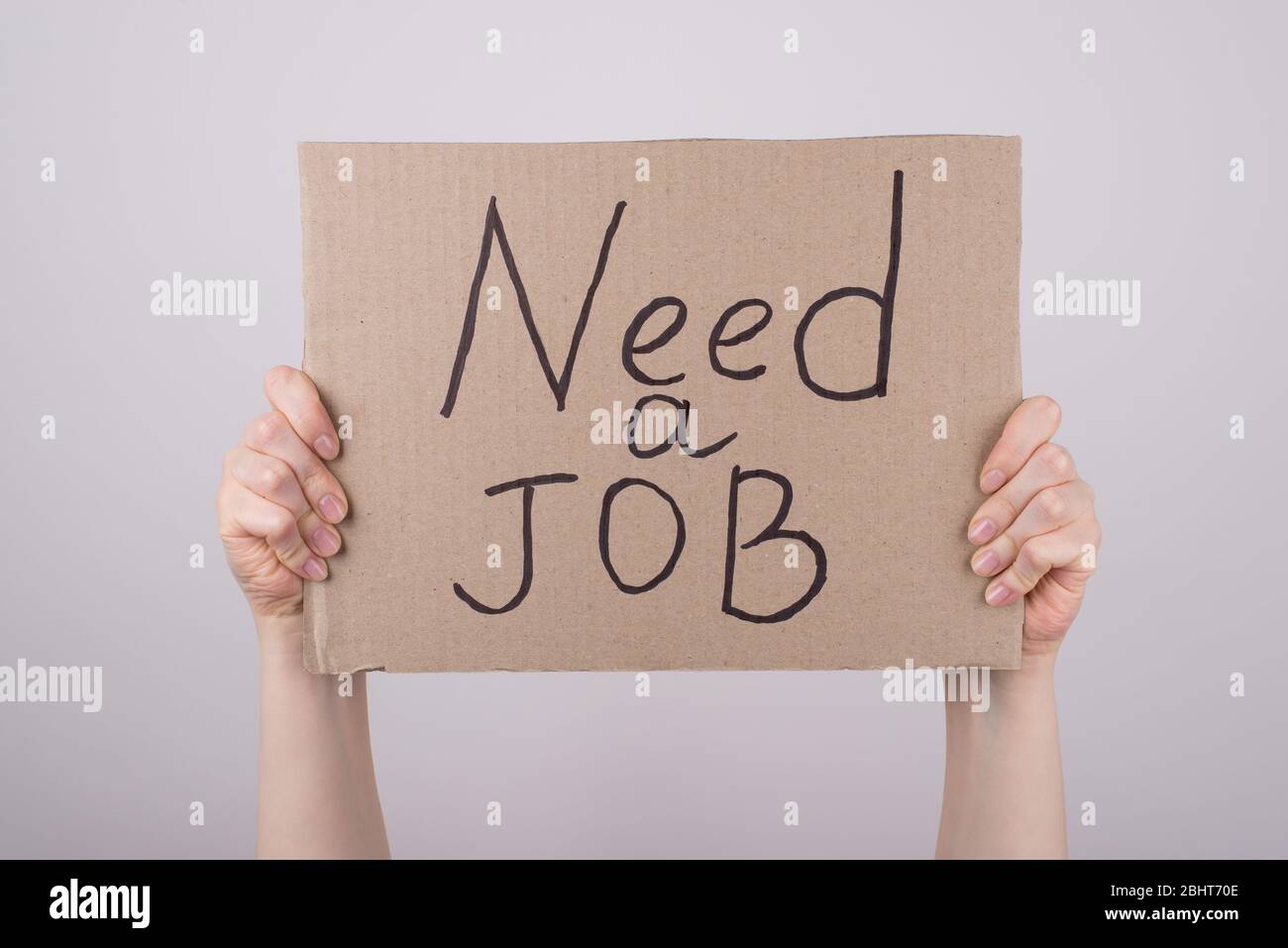 Need a job concept. Cropped close up photo of hands arms showing carton ...