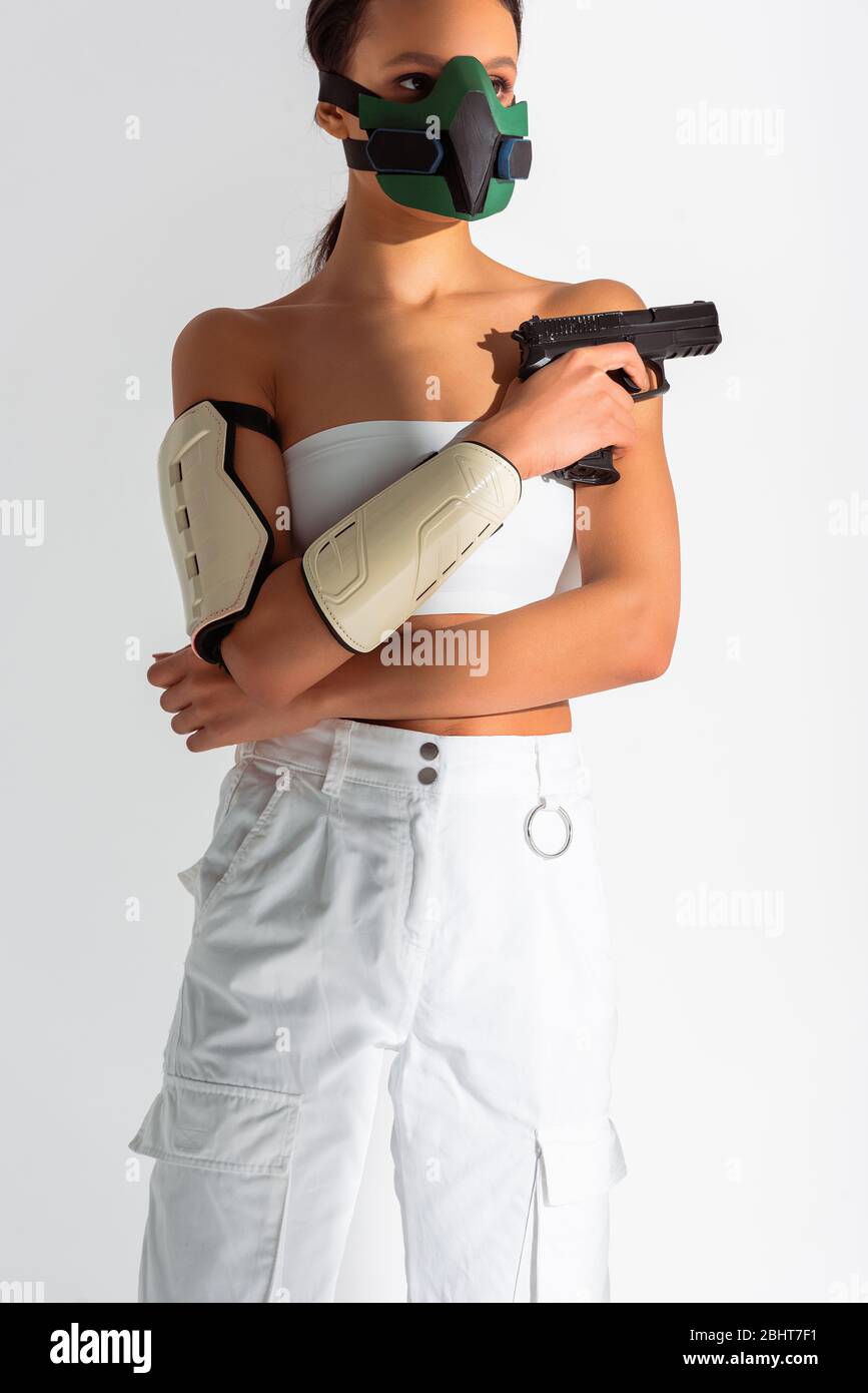 futuristic african american woman in safety mask with gun isolated on ...