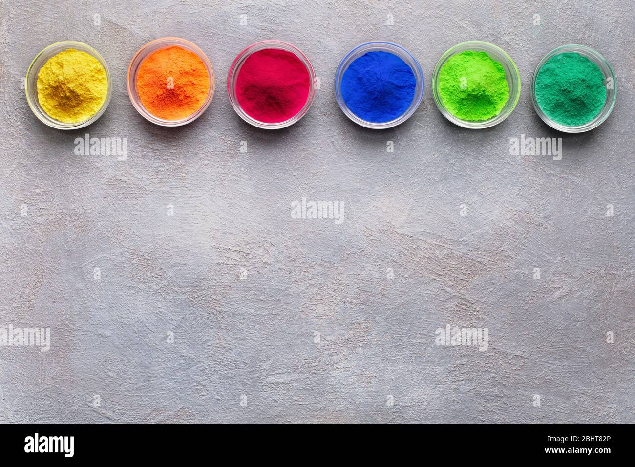 Many bright colors in bowls on gray background Stock Photo - Alamy