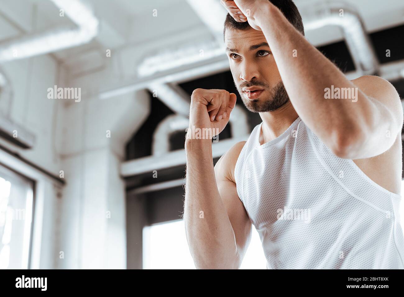 strong fighter with clenched fists training in sports center Stock ...