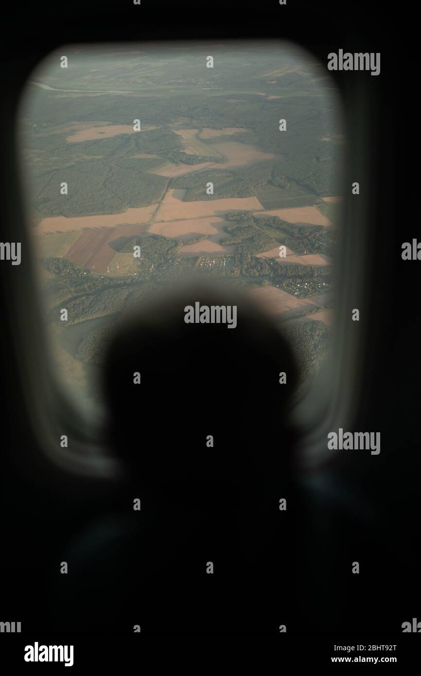 Woman looking through window of plane hi-res stock photography and ...