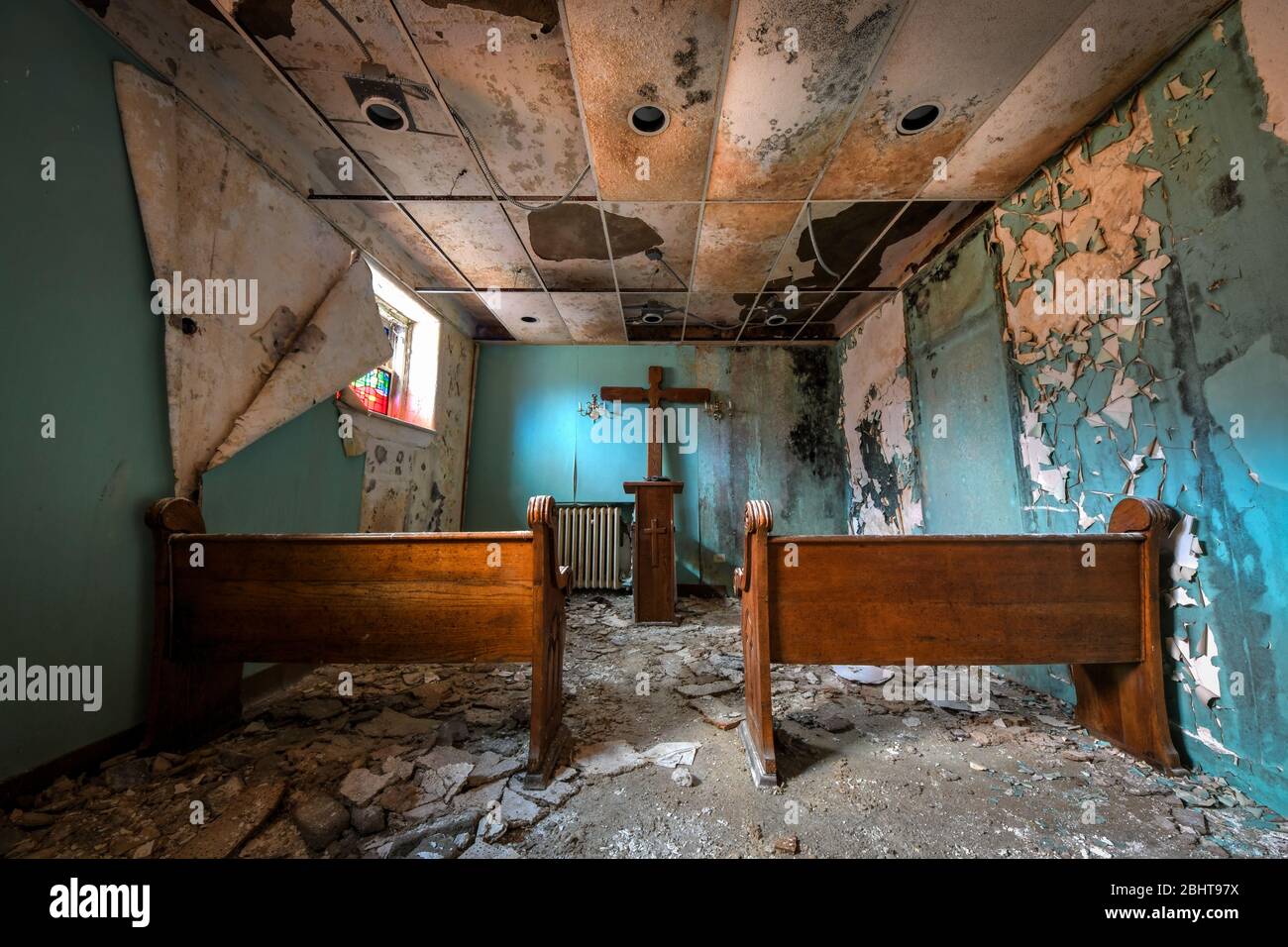 empty church in an abandoned hospital with stained glass windows ...