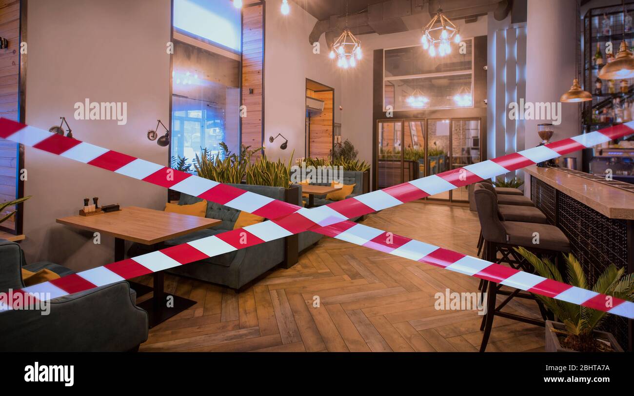 Hazard safety stripes across empty closed restaurant Stock Photo - Alamy