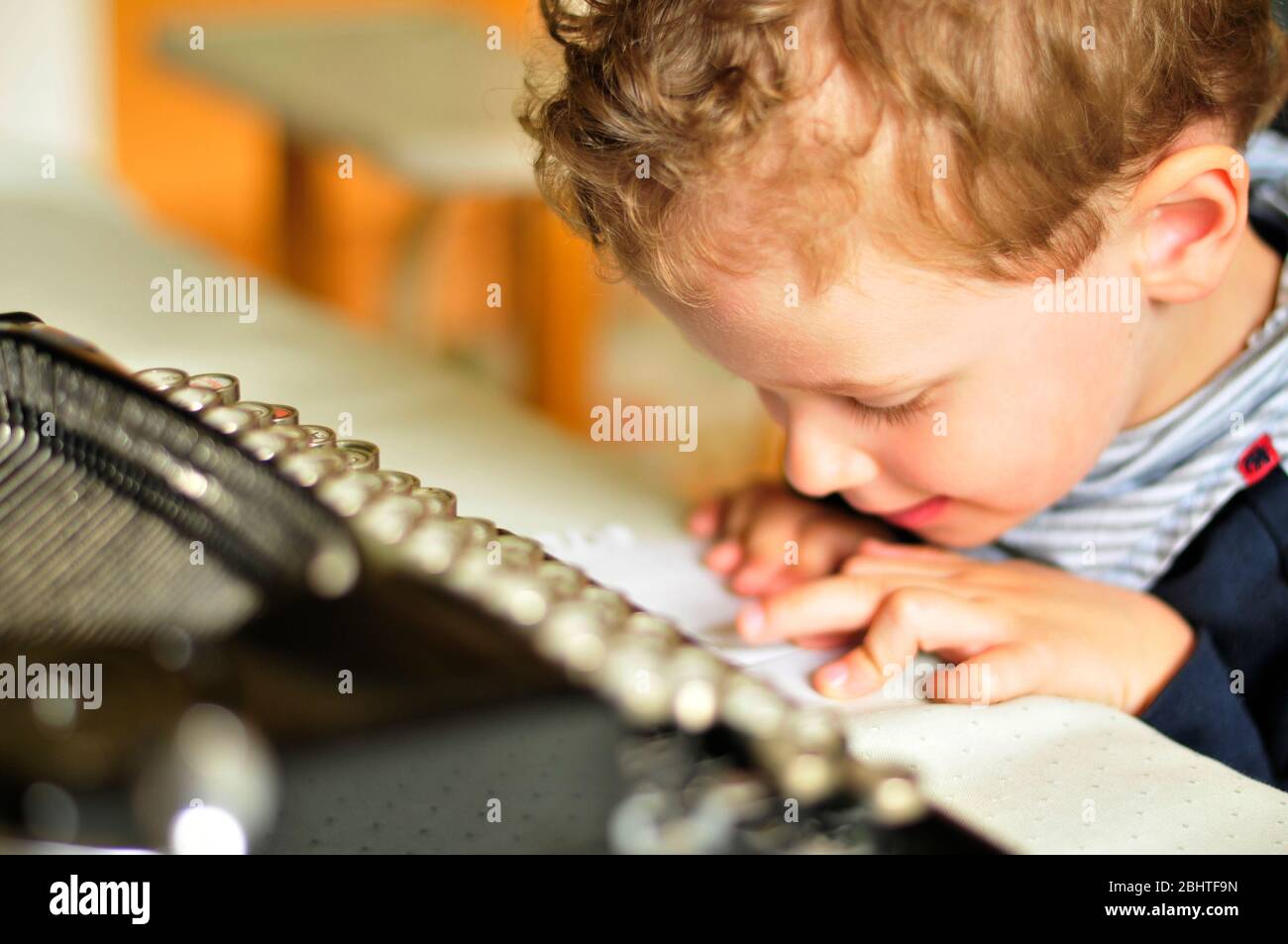 Child learns to read with a typewriter out of focus Stock Photo - Alamy