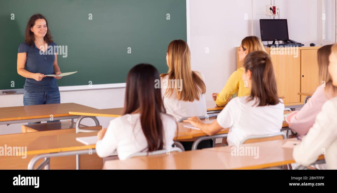 Female speaker giving lesson for university students in lecture hall ...