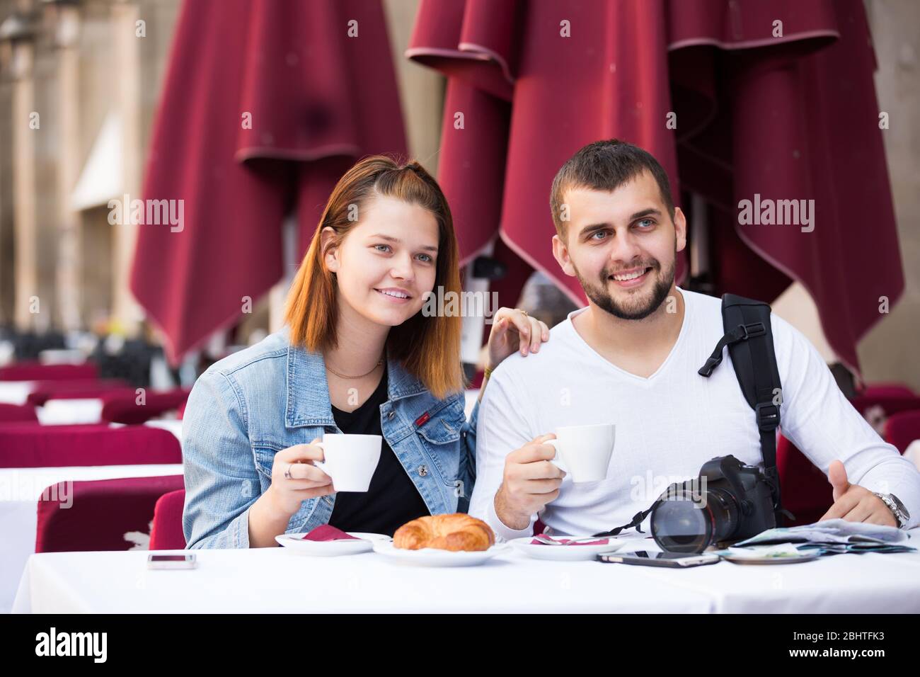 Positive teenagers drinking coffee with bakery Stock Photo - Alamy