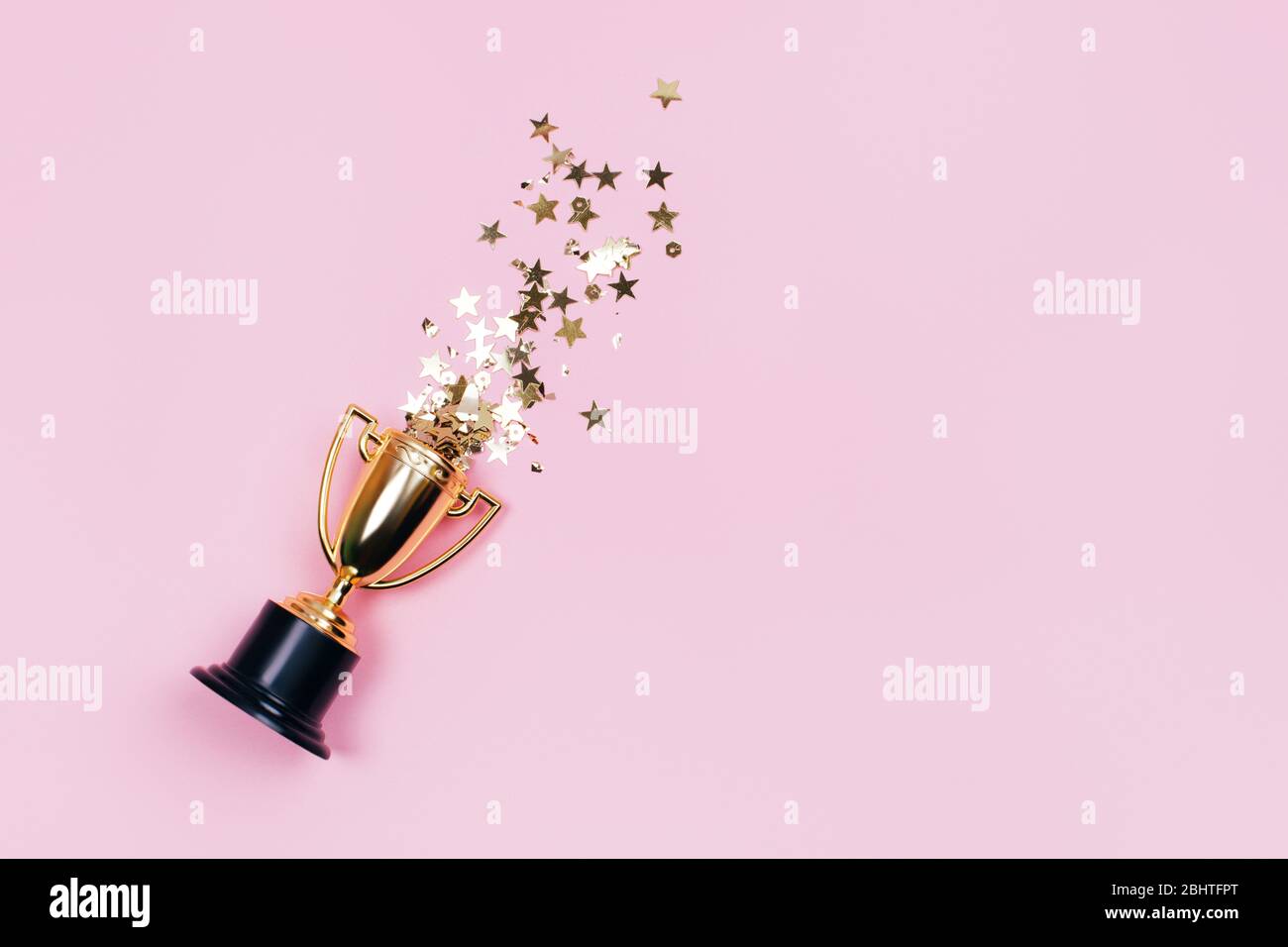 One winners cup with golden sparkles on a pastel background. Banner ...