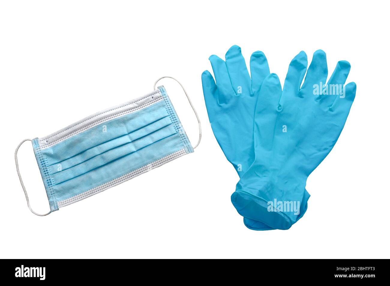 Horizontal shot of a protective face mask laying next to a pair of ...