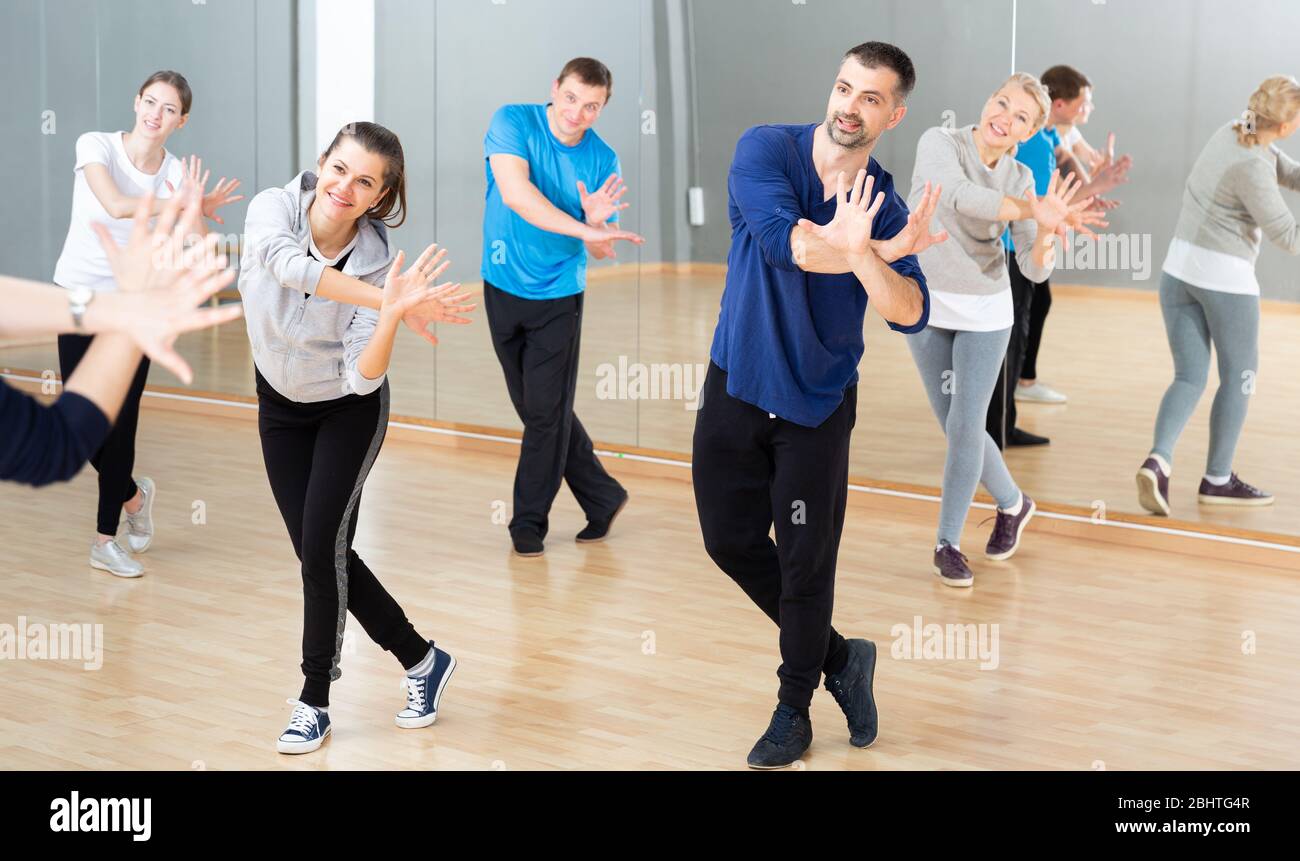 Group of happy adult people enjoying active social dances in modern ...