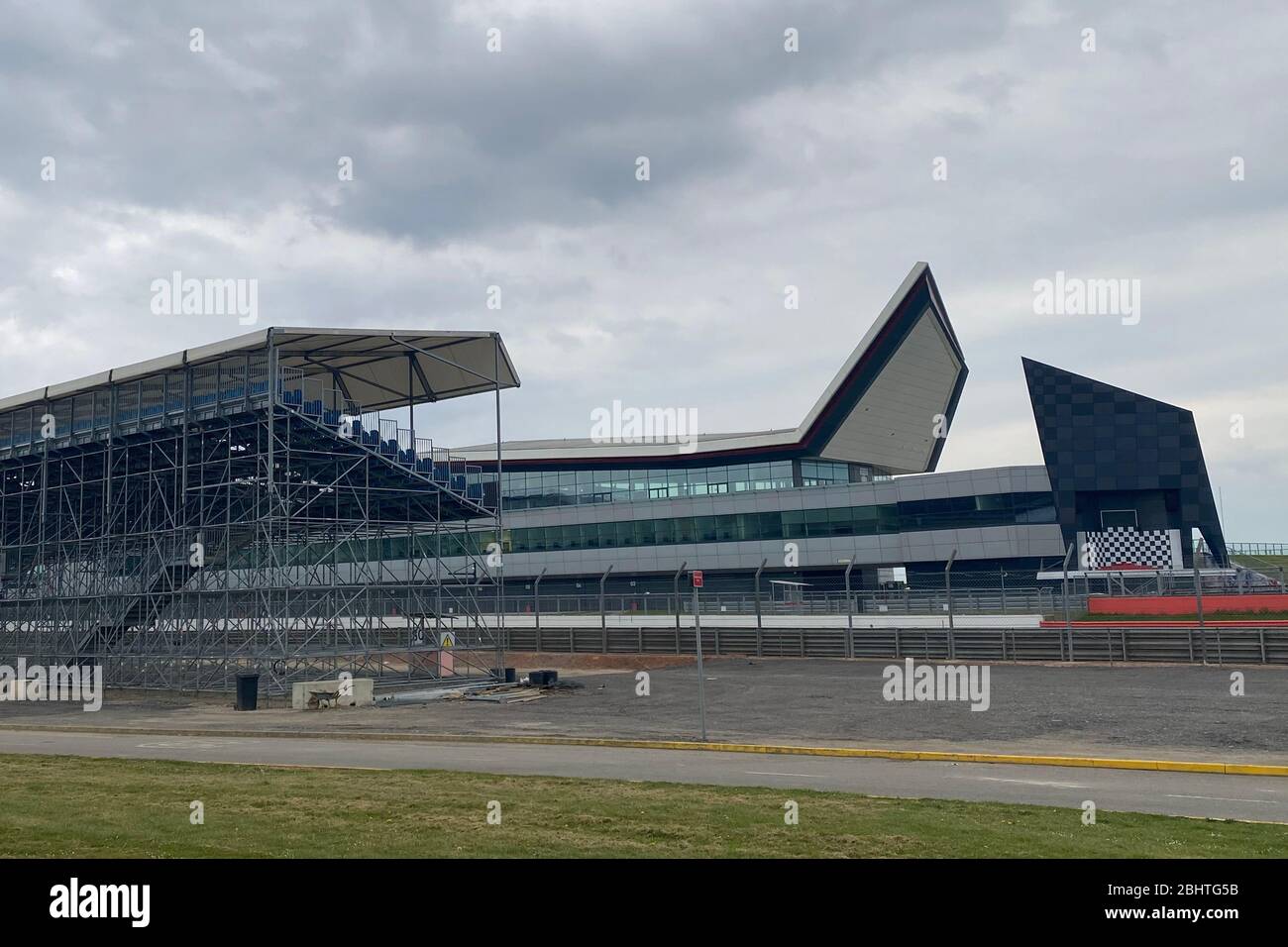 The Silverstone wing pits building opposite an empty grandstand. The ...