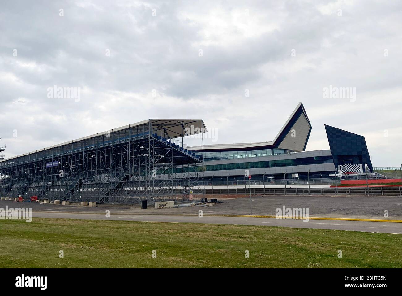 The Silverstone wing pits building opposite an empty grandstand. The ...