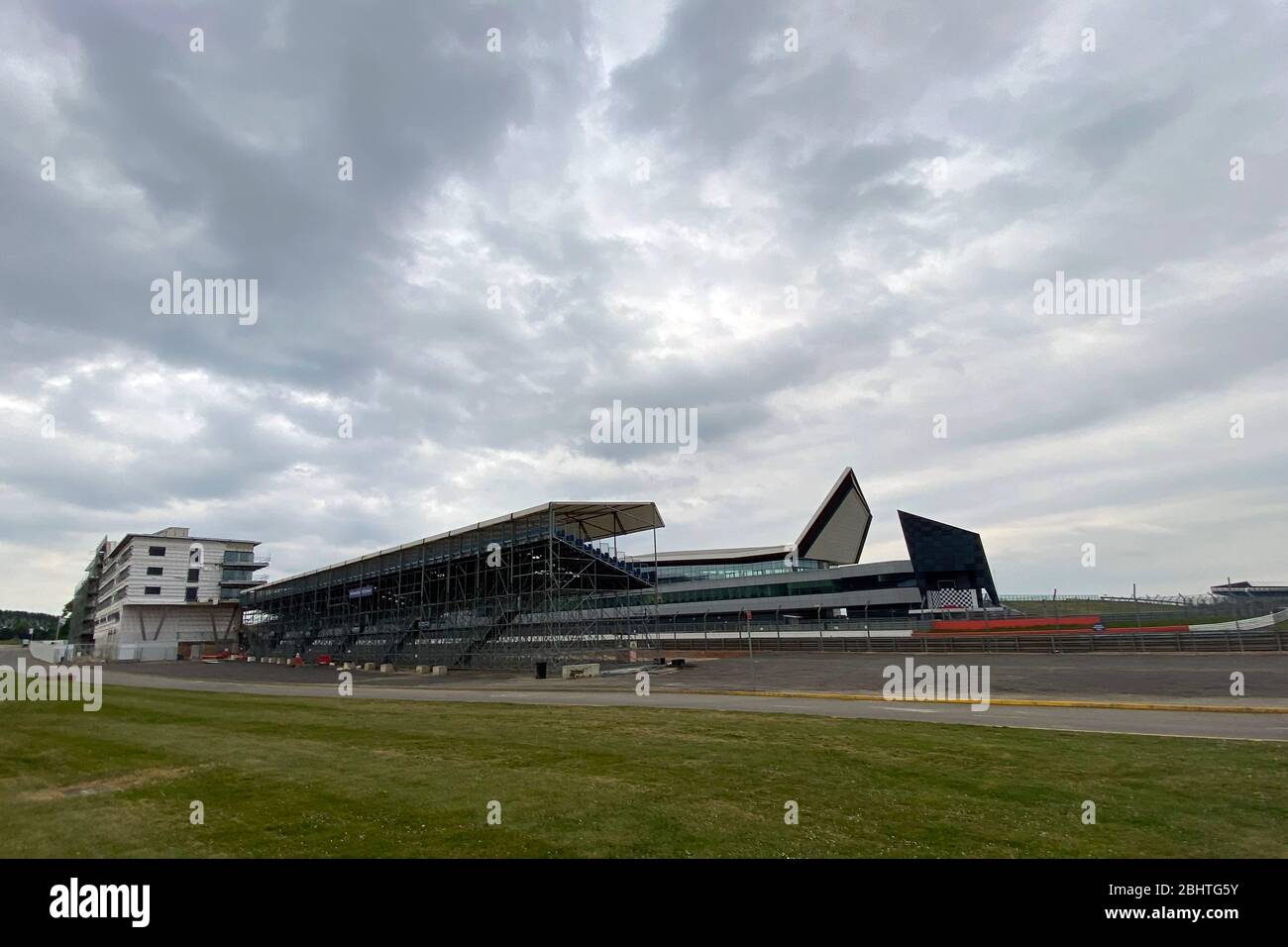 The Silverstone wing pits building opposite an empty grandstand. The ...
