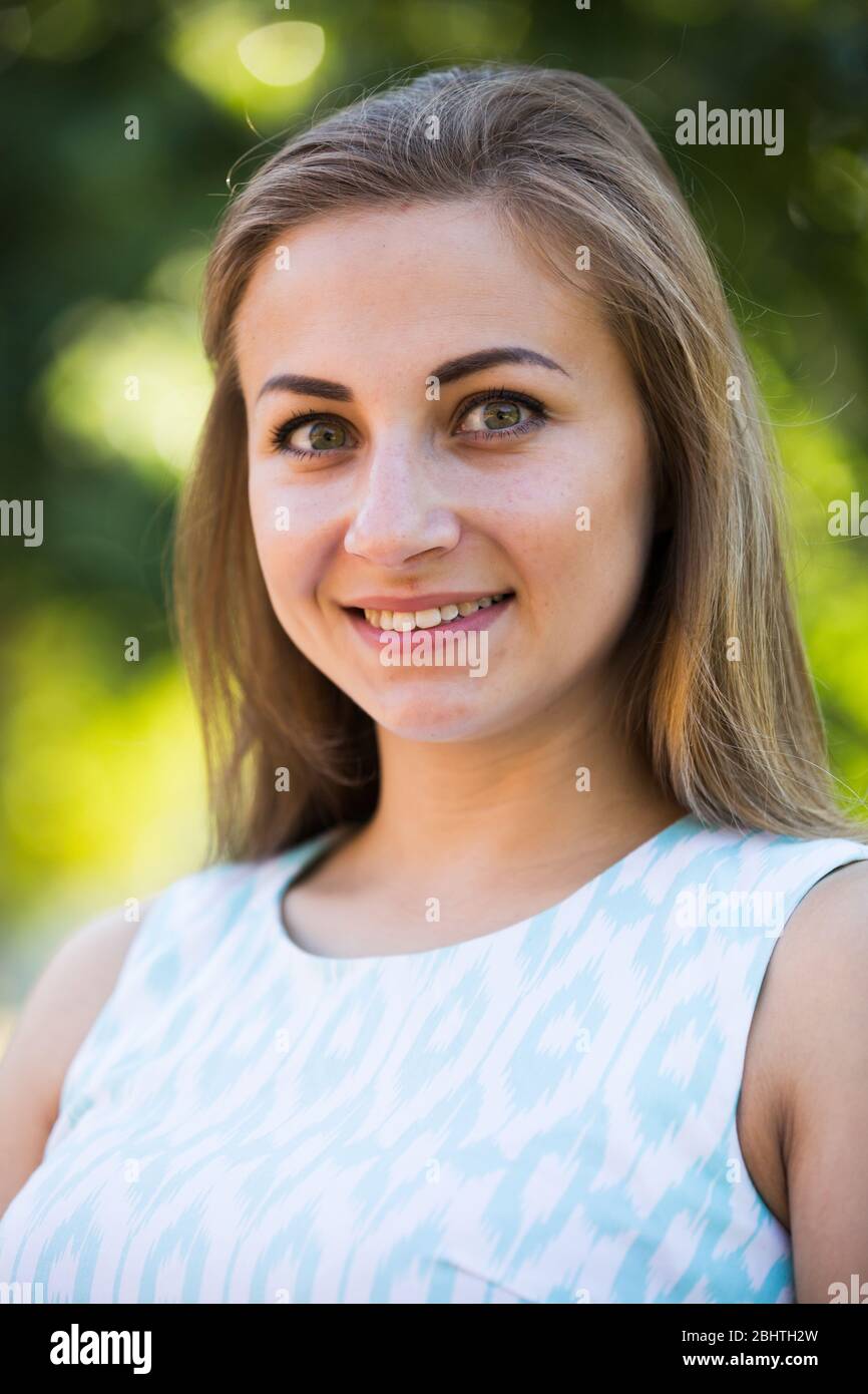 portrait of cheerful smiling young british woman portrait in outdoor ...