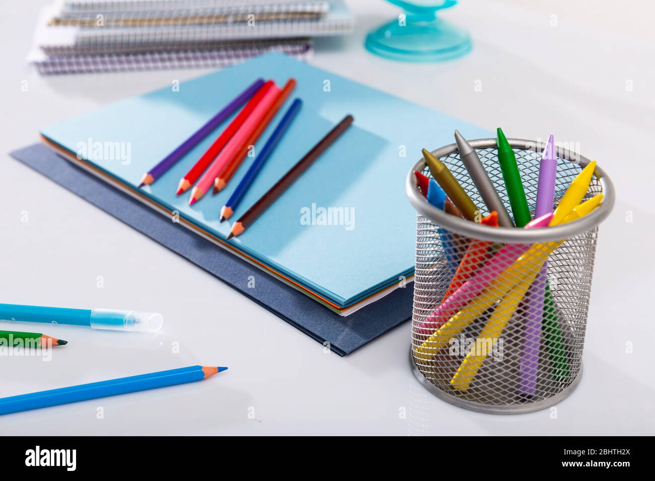 Variety of colorful pencils and crayons lying on wooden table with ...