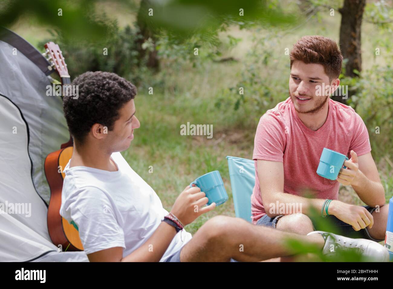 men in the campsite talking Stock Photo - Alamy