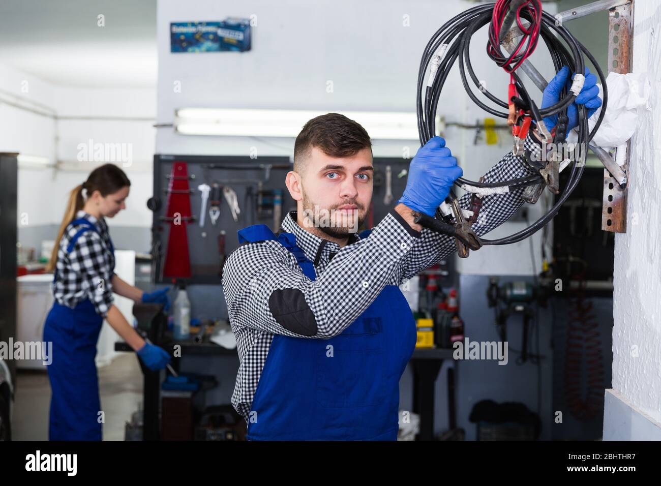 Portrait of master who is posing on his workplace in workshop Stock ...