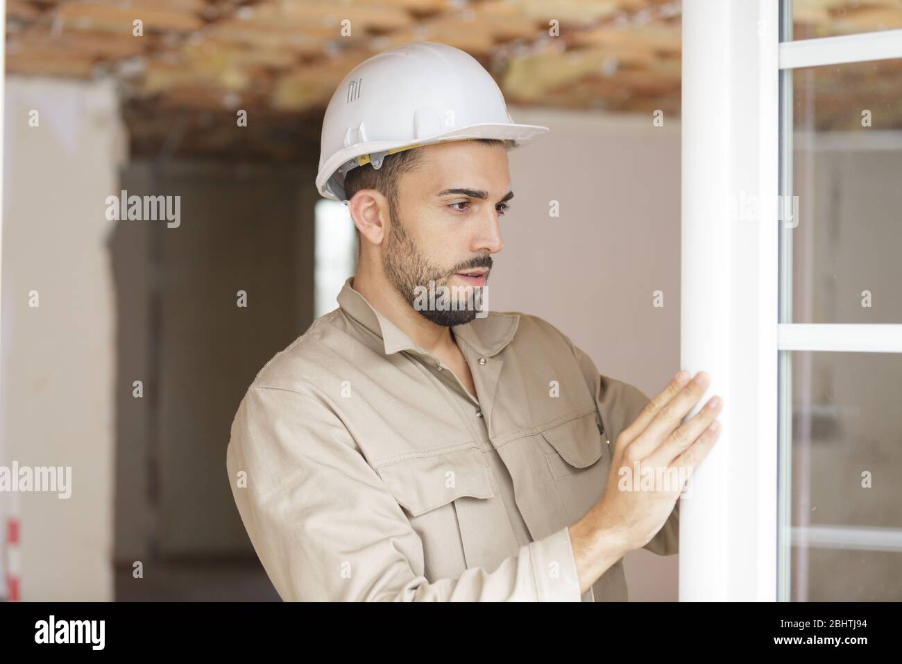 construction worker fixing a window Stock Photo - Alamy
