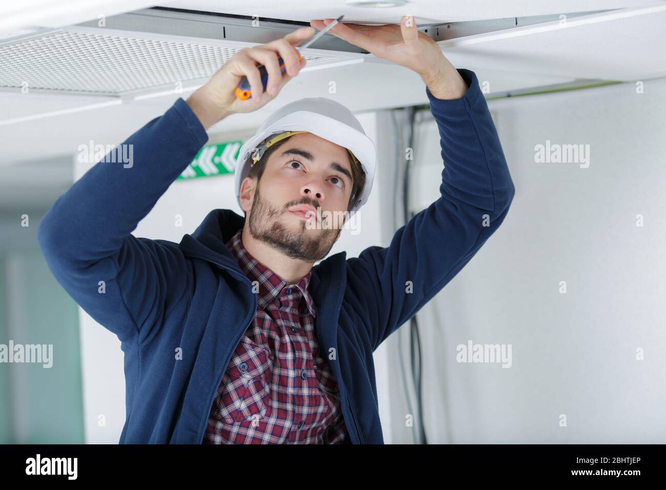 male construction fixing ceiling board Stock Photo - Alamy