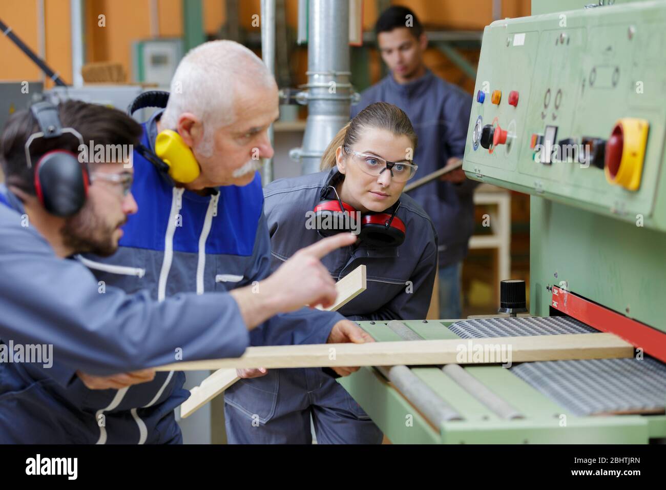engineers at wood cutting machine Stock Photo - Alamy