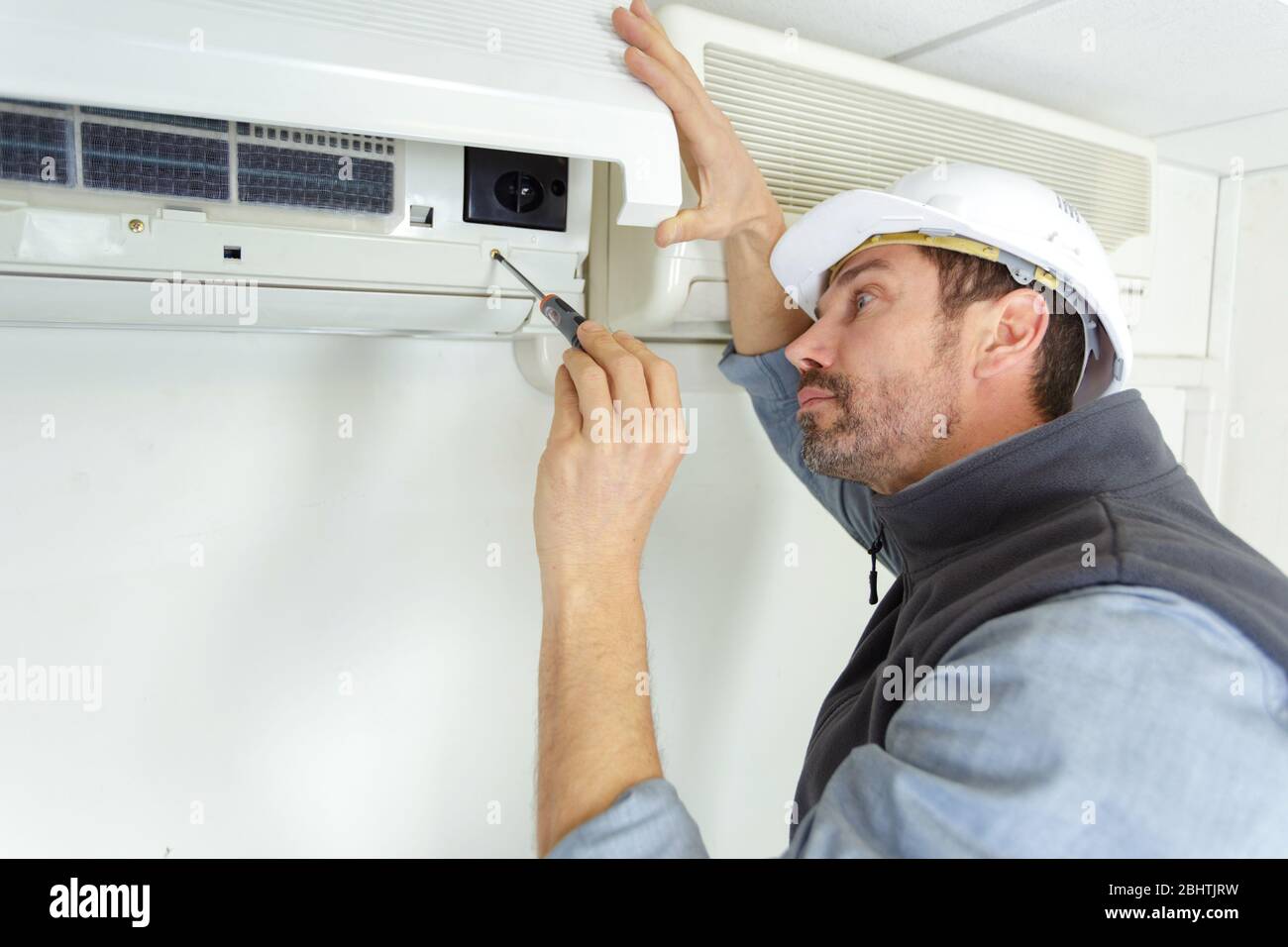 fixing and maintaining air conditioning system Stock Photo - Alamy