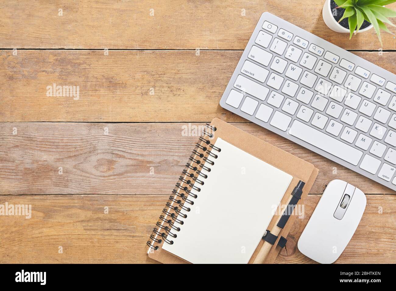 Computer Keyboard paper Notepad mouse plant on wooden table with copy ...