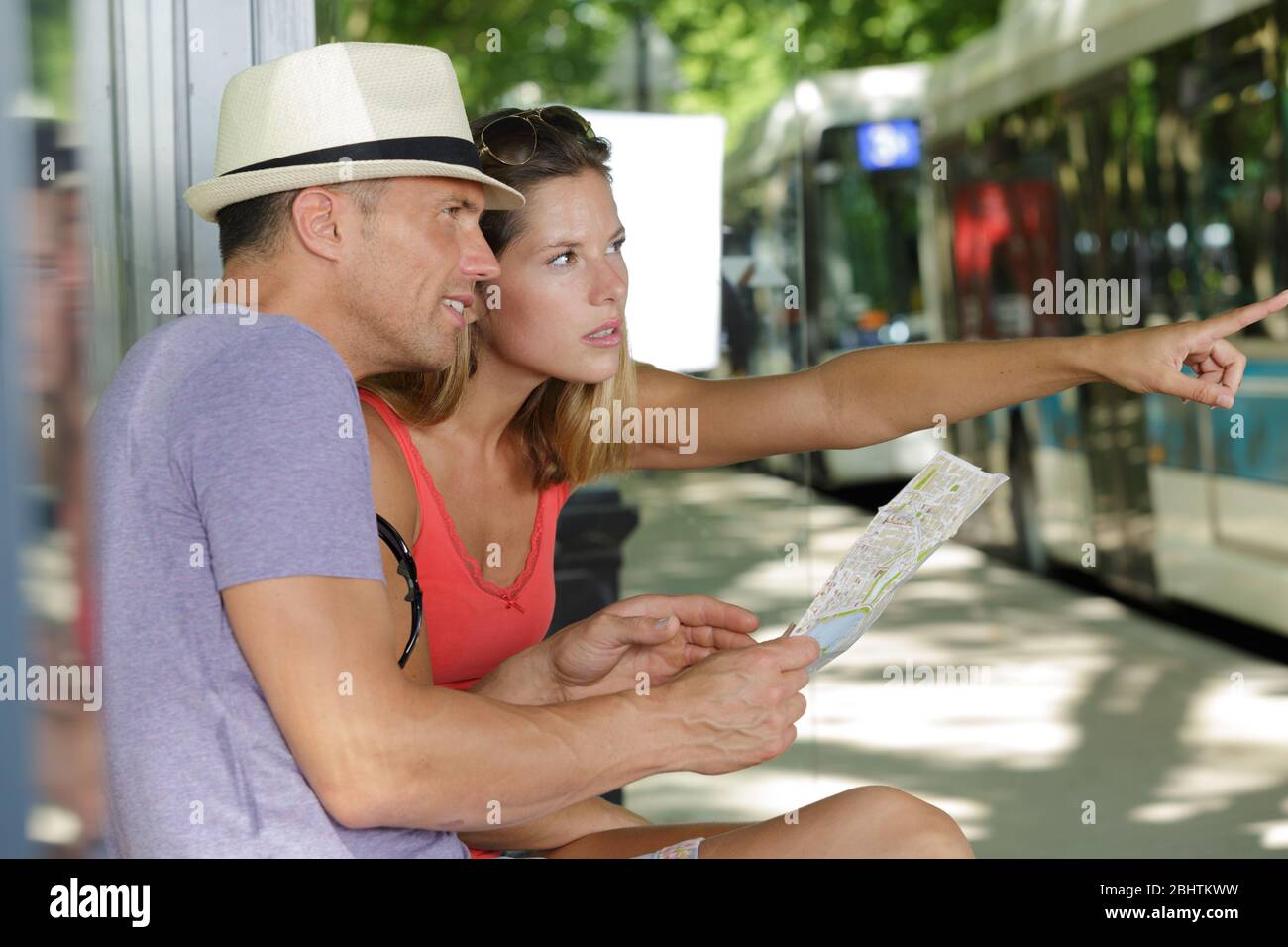people at bus station waiting for a bus Stock Photo - Alamy