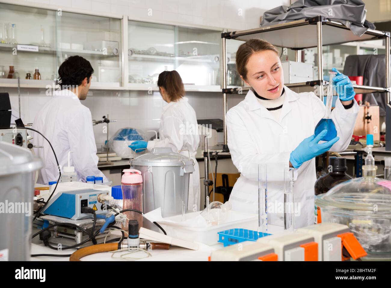 Female student performing experiments in university laboratory ...