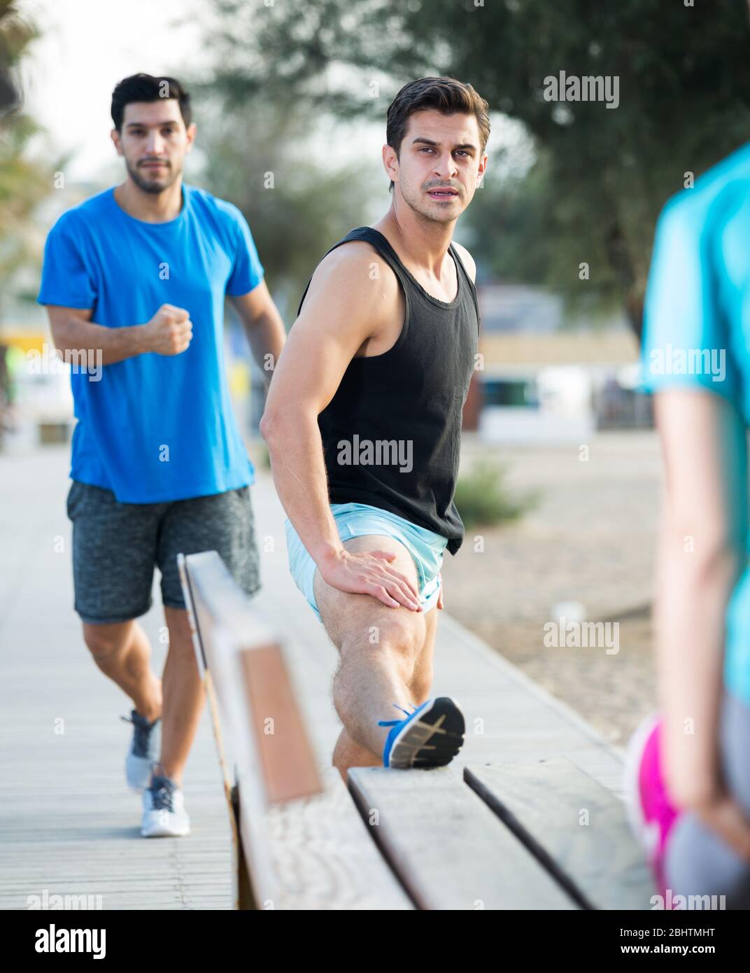 Two friends are doing warm-up in the park near ocean Stock Photo - Alamy