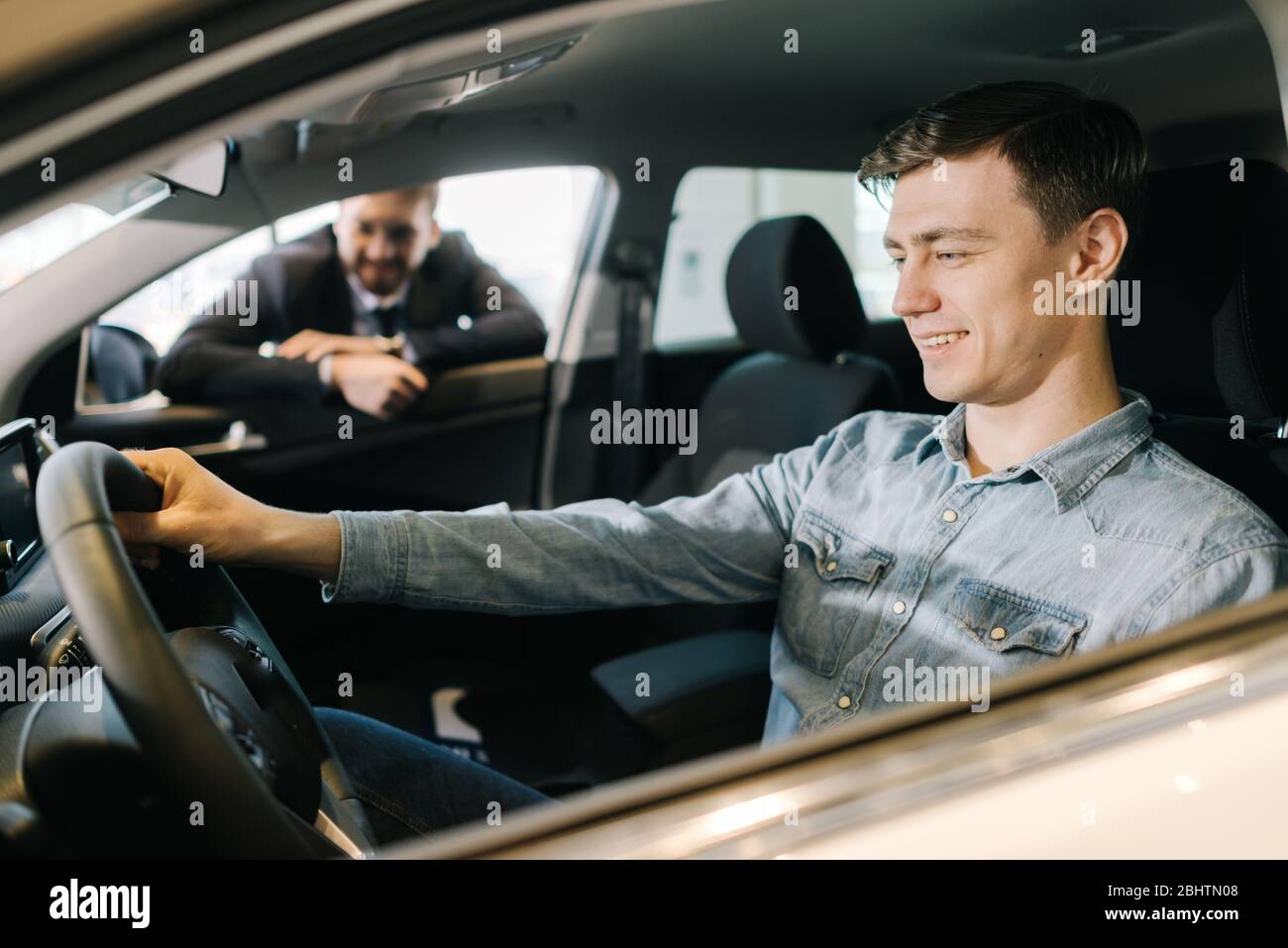 Businessman smiling behind car hi-res stock photography and images - Alamy