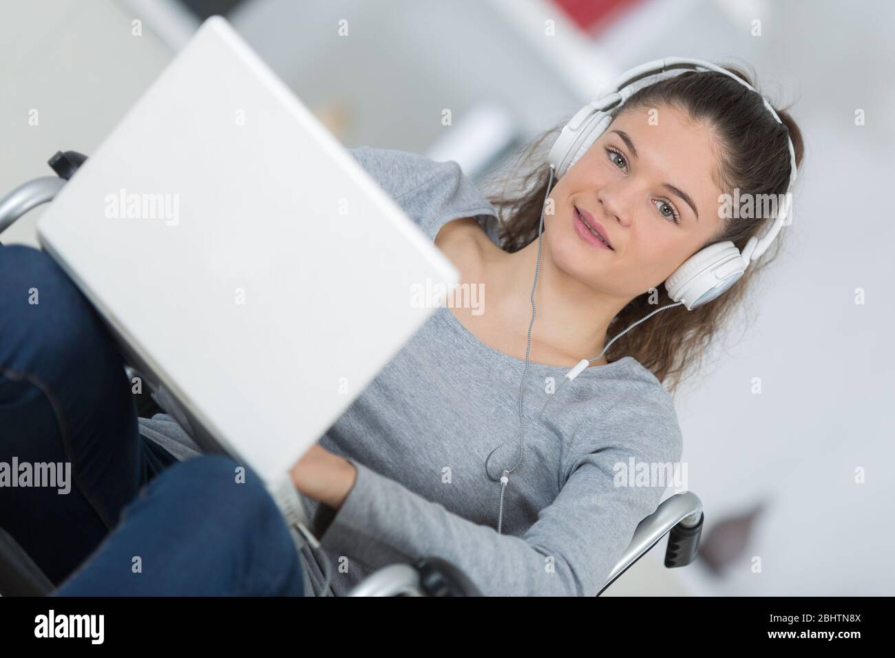 disabled young woman in wheelchair using a laptop Stock Photo - Alamy