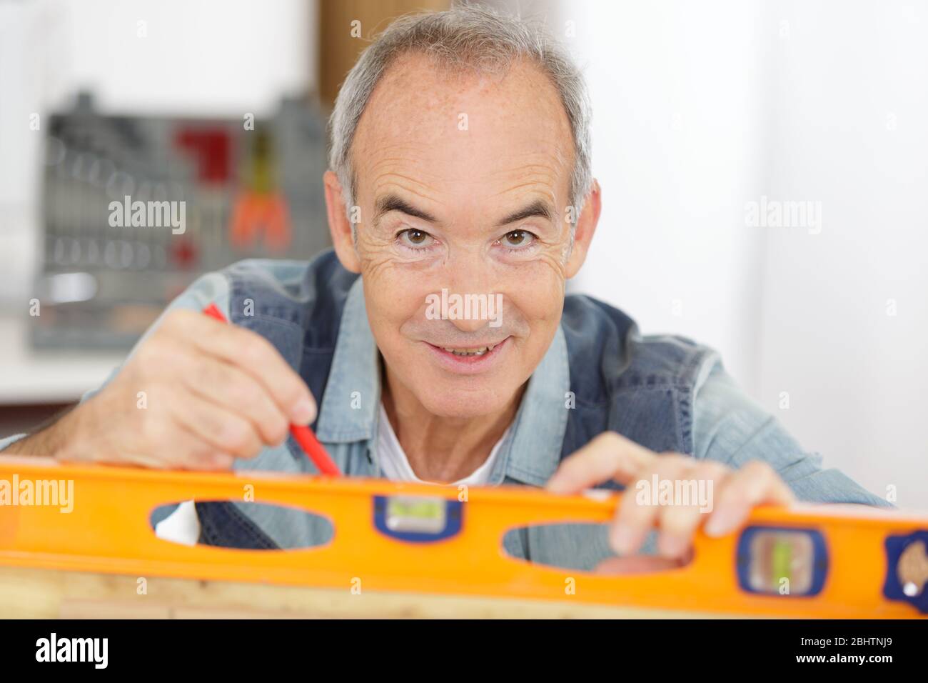 Elderly carpenter measuring work hi-res stock photography and images ...