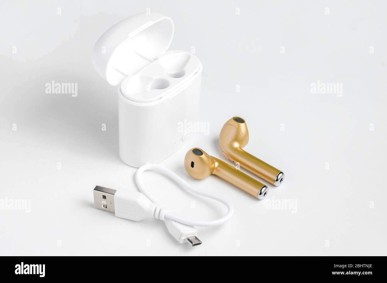 Close-up of golden bluetooth headphones for sale at store . New ...