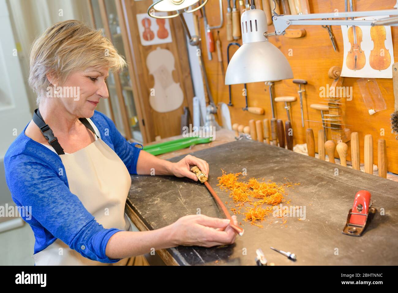 female luthier working on the creation of a violin Stock Photo - Alamy