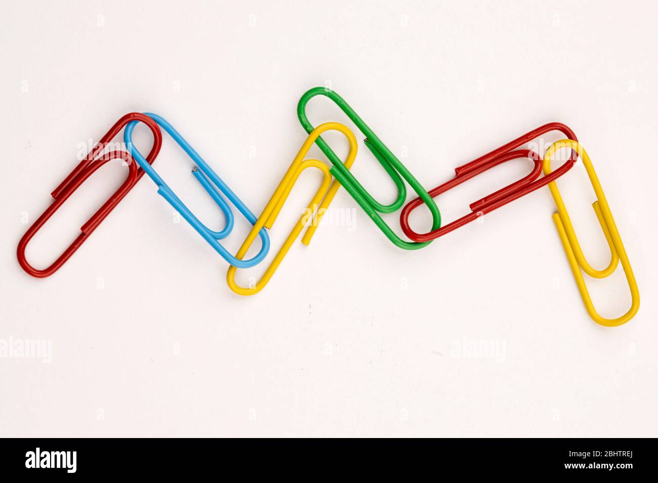 A concept photo of a wavy link of multi-colored paperclips Stock Photo ...