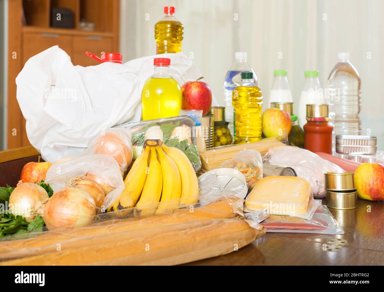 food purchases from supermarket on table in home interior Stock Photo ...