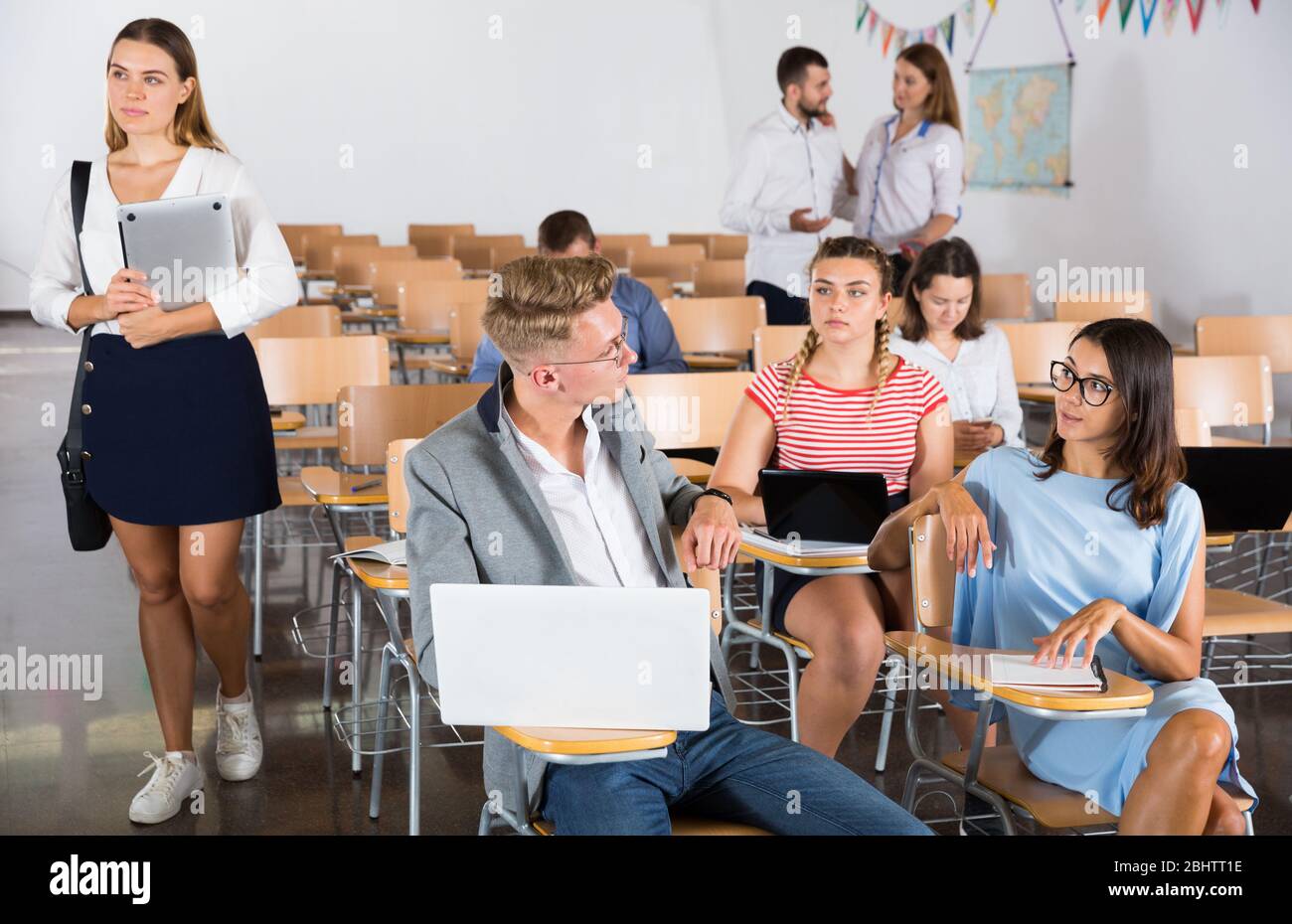 Smiling adult students communicating during recess between lectures in ...
